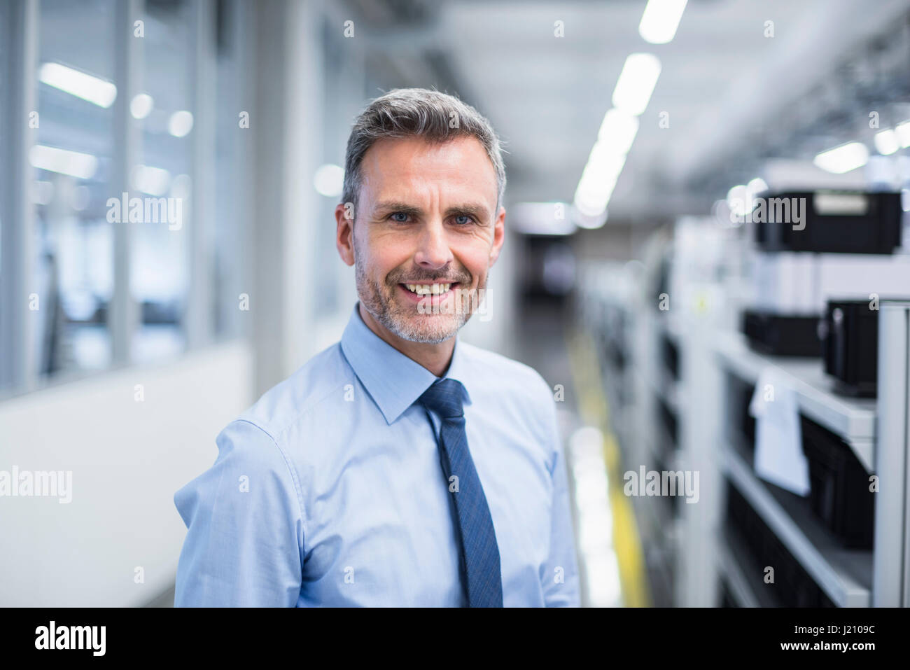 Portrait of a manager on the shop floor of a factory Stock Photo - Alamy