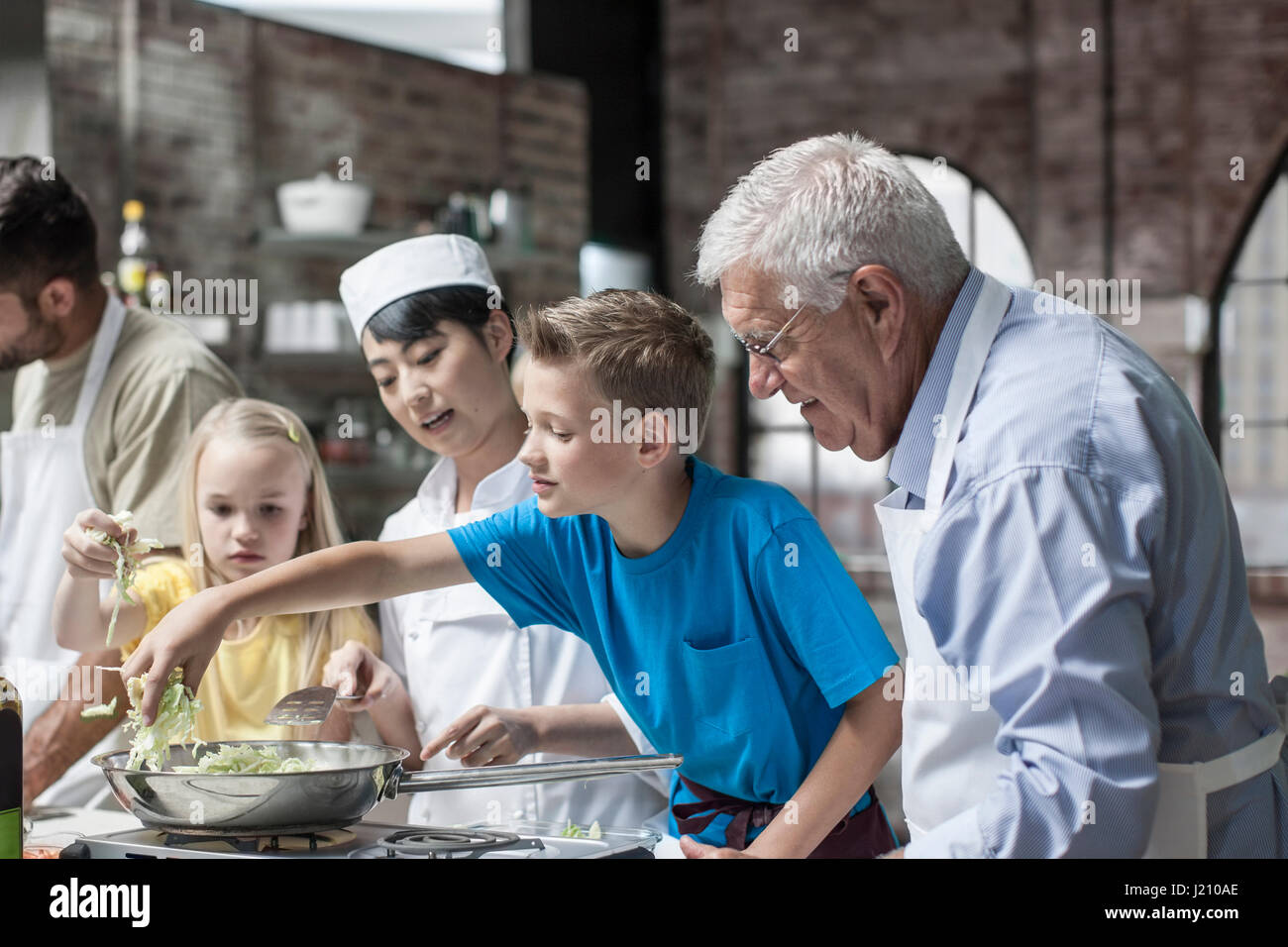 Female chef and students cooking in cooking class Stock Photo - Alamy