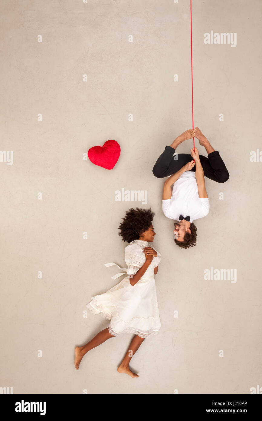 Couple falling in love, man hanging upside down Stock Photo - Alamy