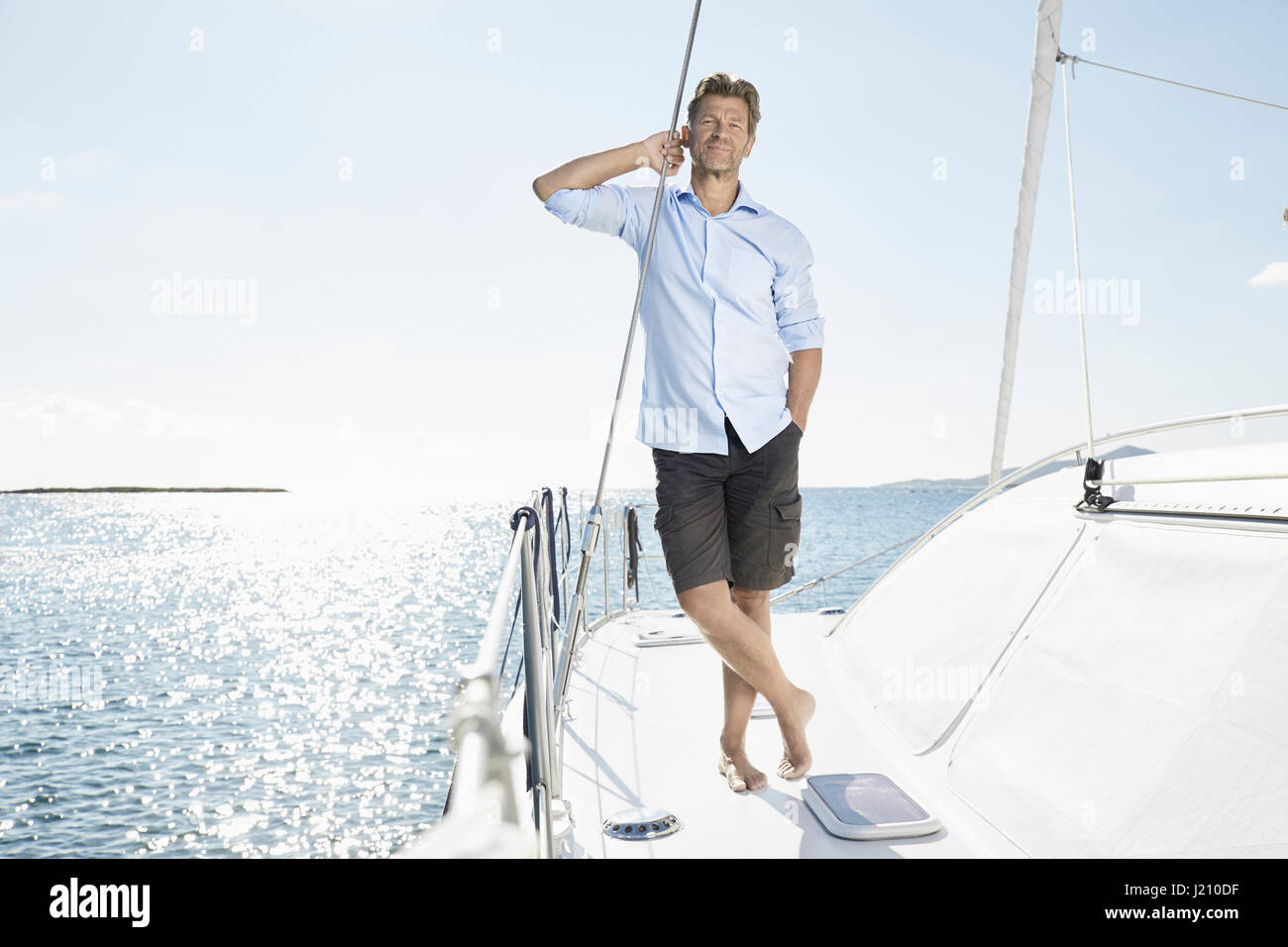 Person standing at front of sailing yacht hi-res stock photography and ...