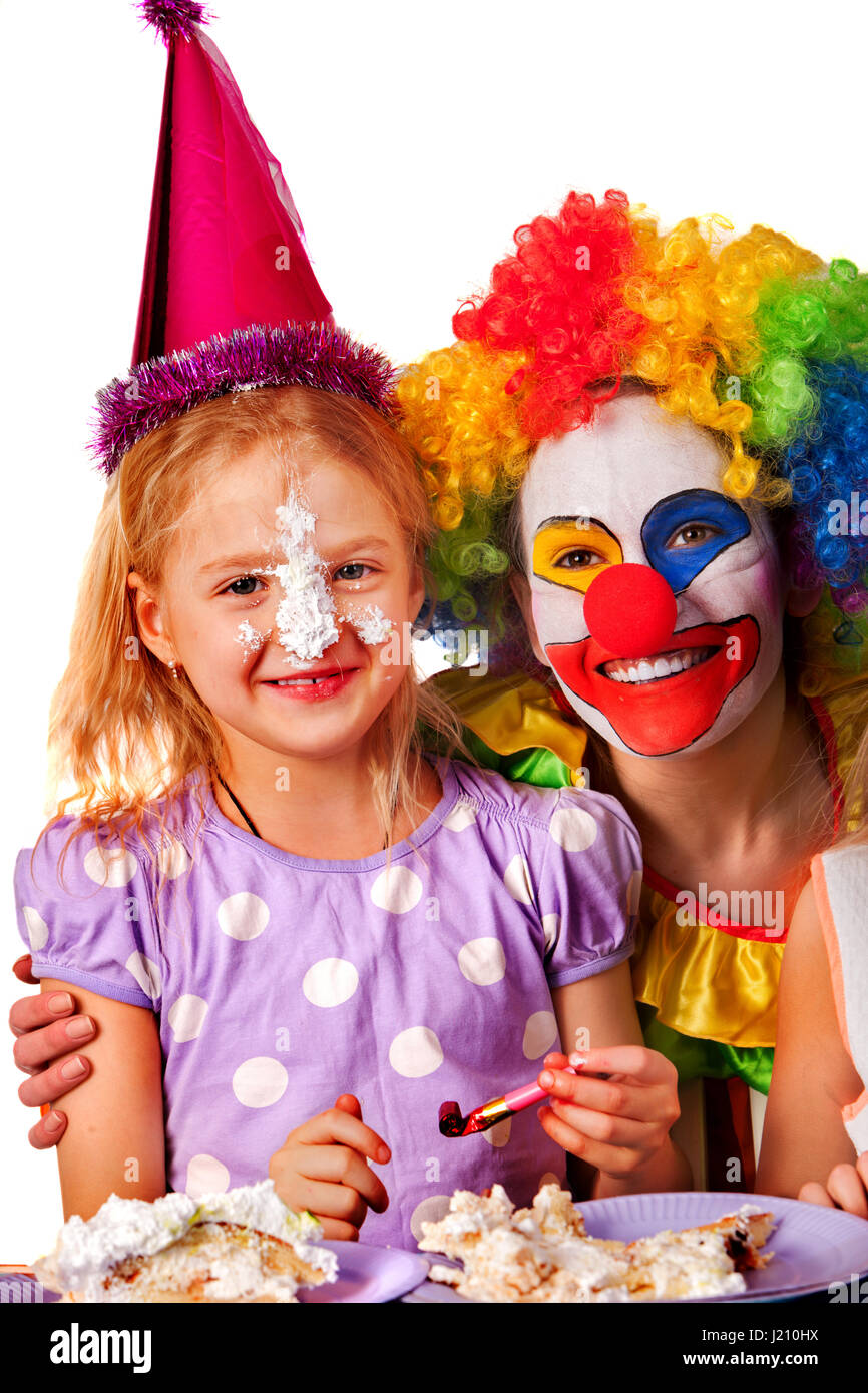 Birthday child clown eating cake with boy together. Kid with messy face ...