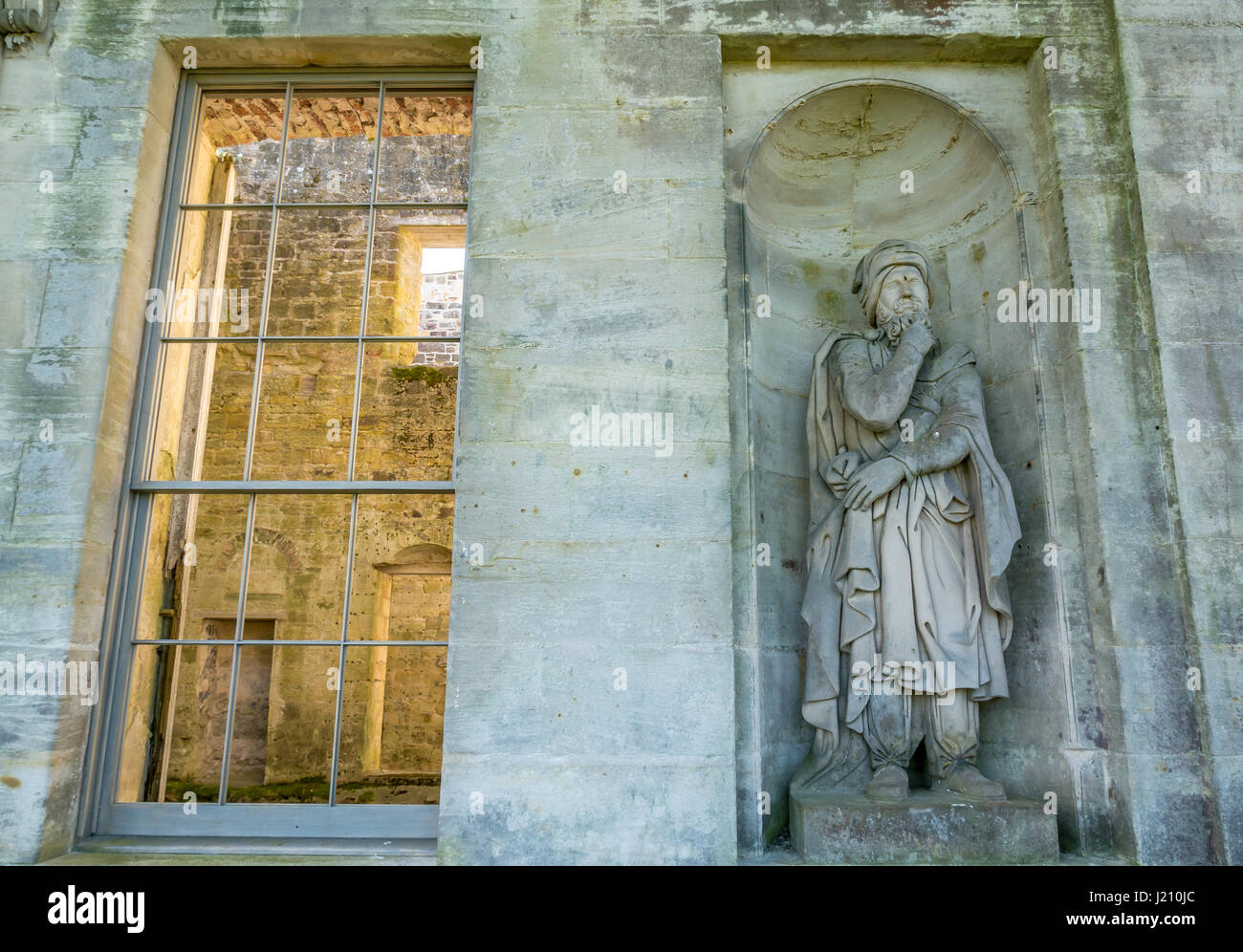 Close up stone Druid statue by Willie Jeans and sash and case window ...