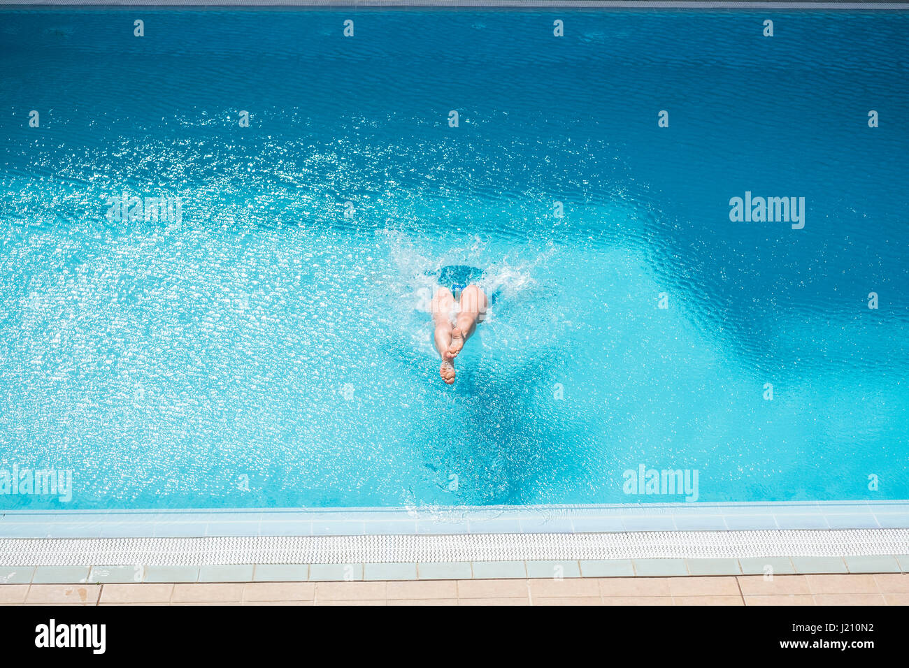 Woman jumping into swimming pool Stock Photo - Alamy