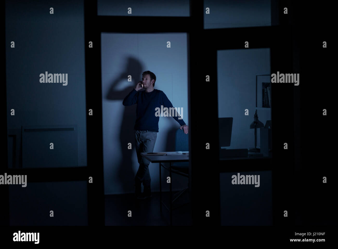 Man working late in office Stock Photo - Alamy