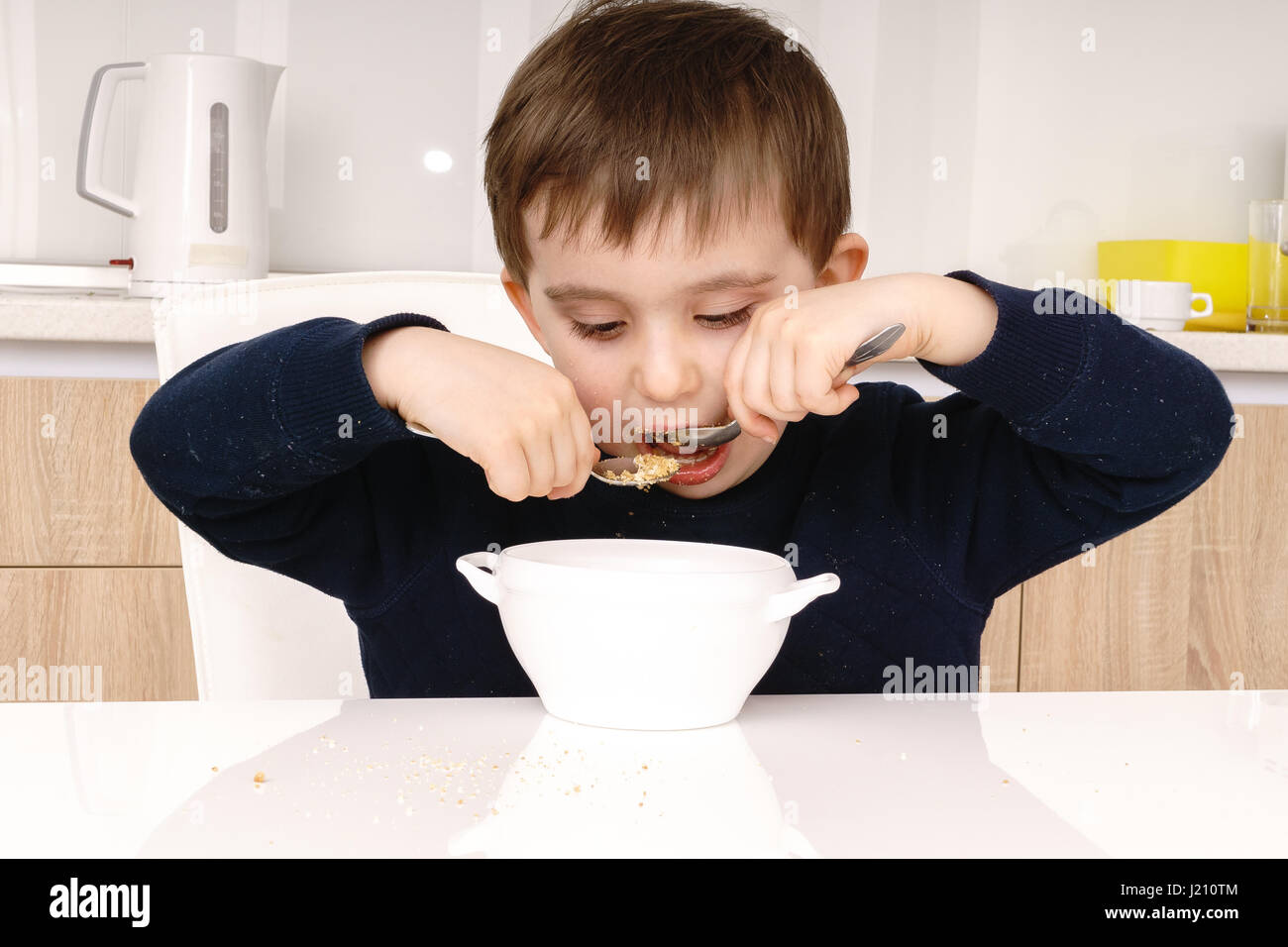 Happy little boy having healthy breakfast Stock Photo - Alamy