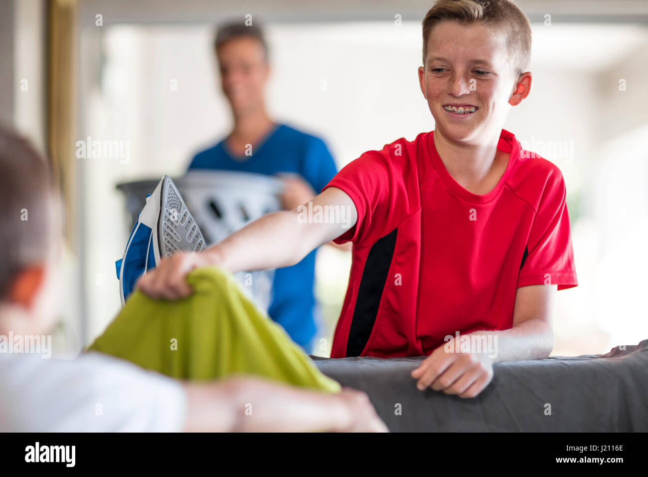 Boy helping with household chores hi-res stock photography and images ...