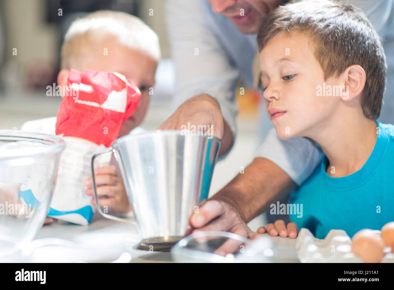 Boy helping to cook in kitchen Stock Photo - Alamy