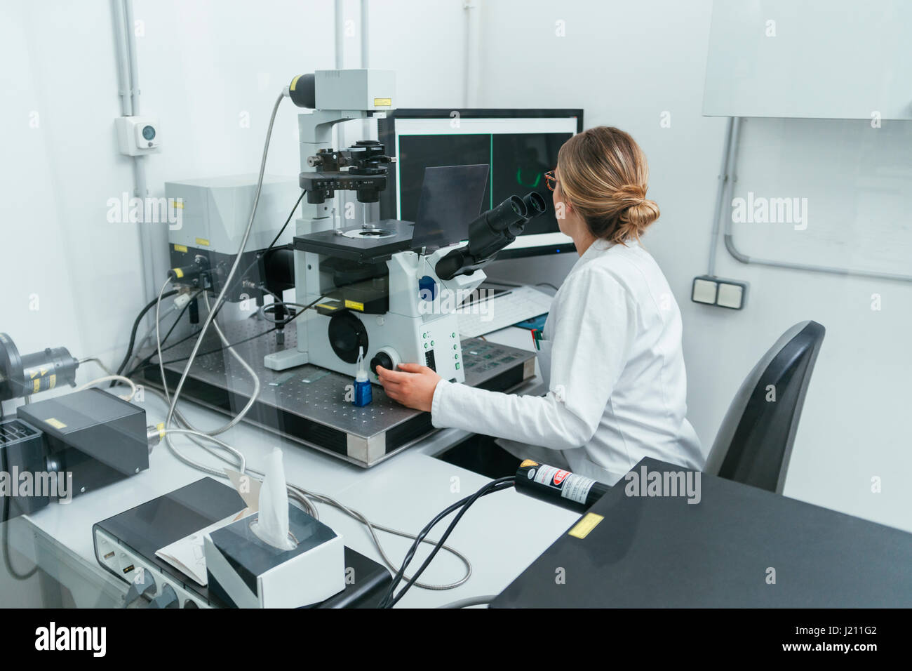 Laboratory technician working in modern lab Stock Photo - Alamy
