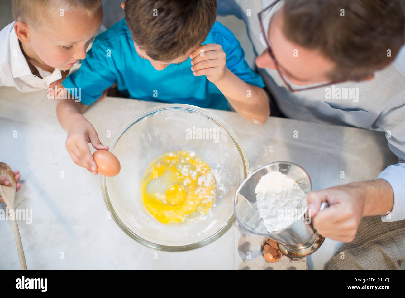 Father and two boys baking in kitchen Stock Photo - Alamy