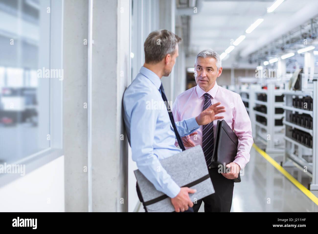 Two managers talking in the company Stock Photo - Alamy