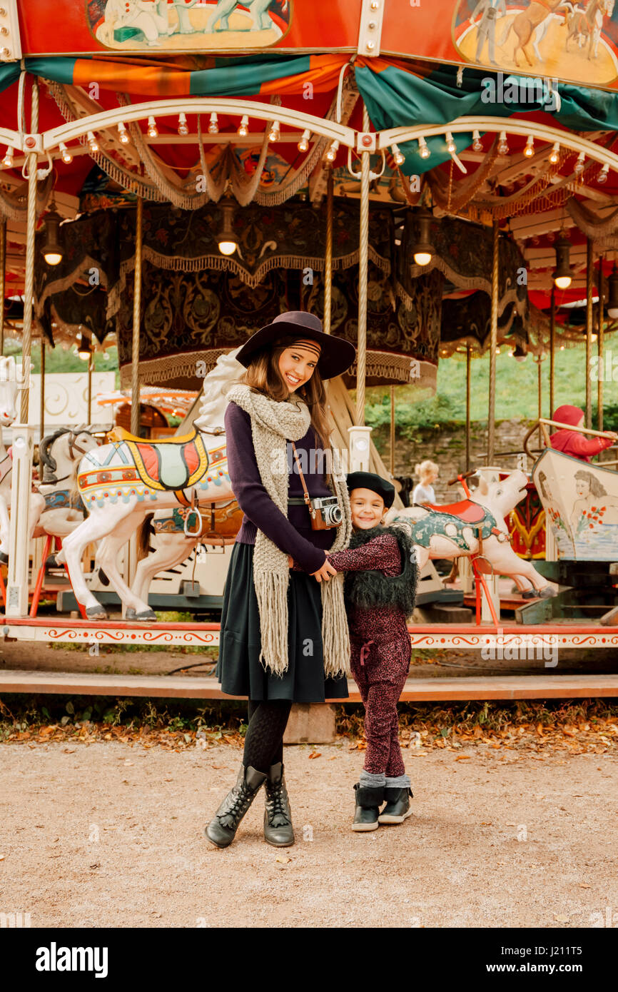 Happy young woman and little girl standing in front of children's ...
