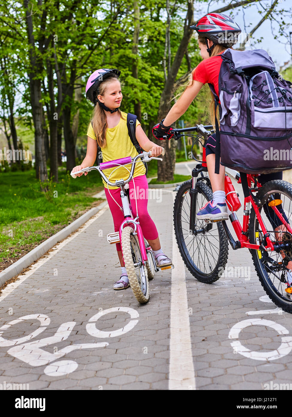 Bicycle path sign with children. Girls wearing helmet with rucksack ...