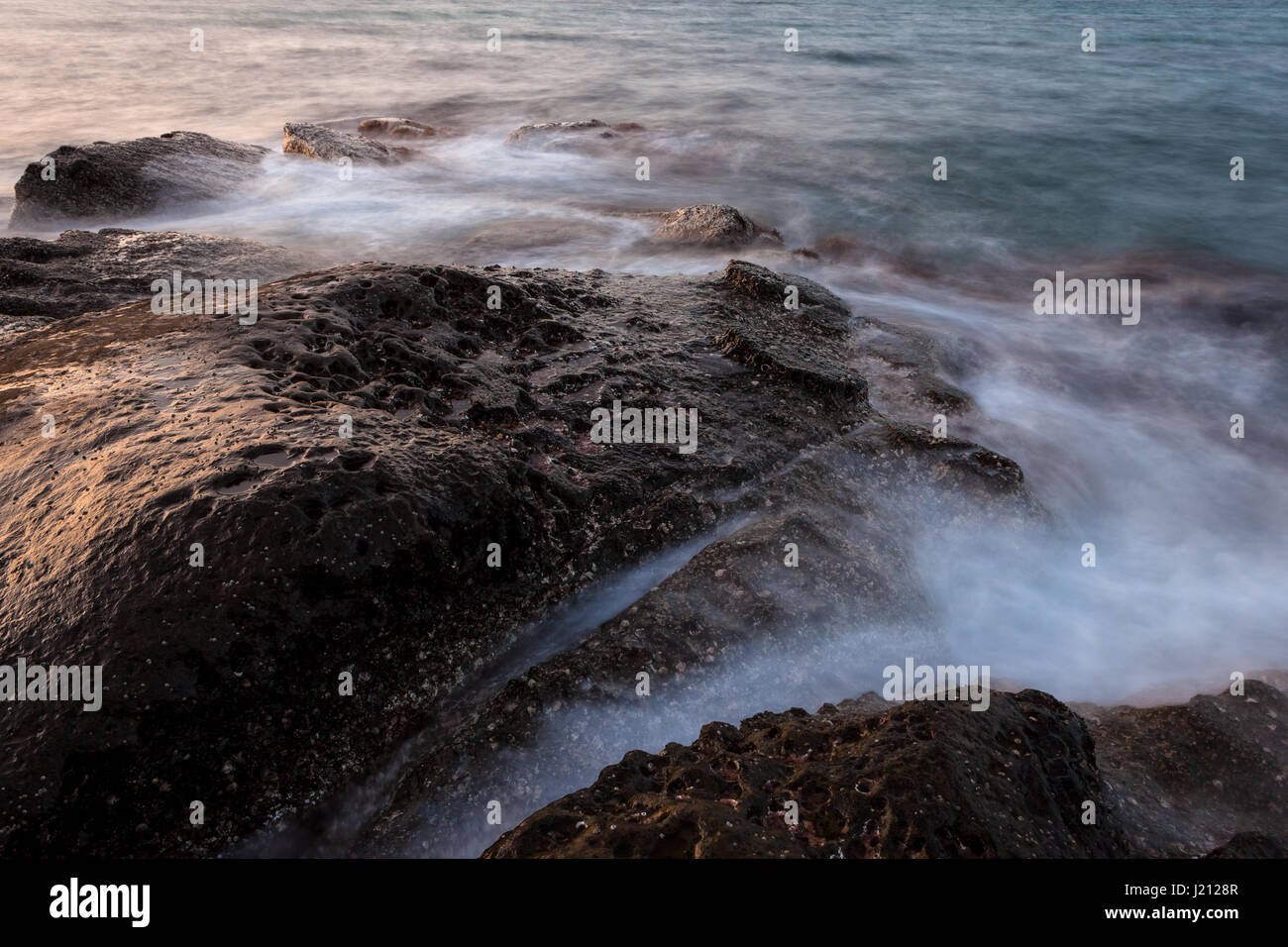 Waves and rocks shore long exposure Stock Photo - Alamy