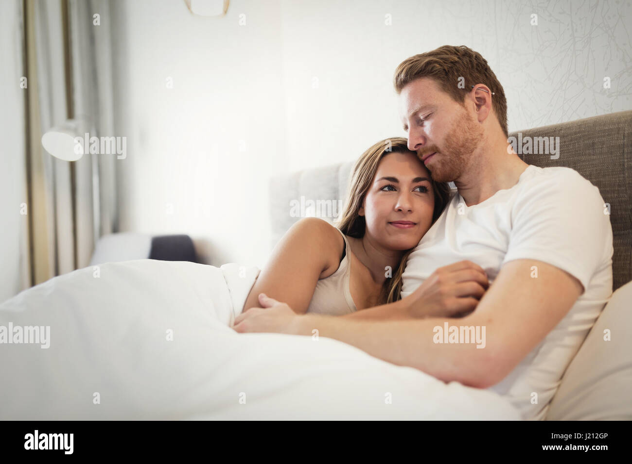 Romantic happy couple in love bonding in bed Stock Photo - Alamy