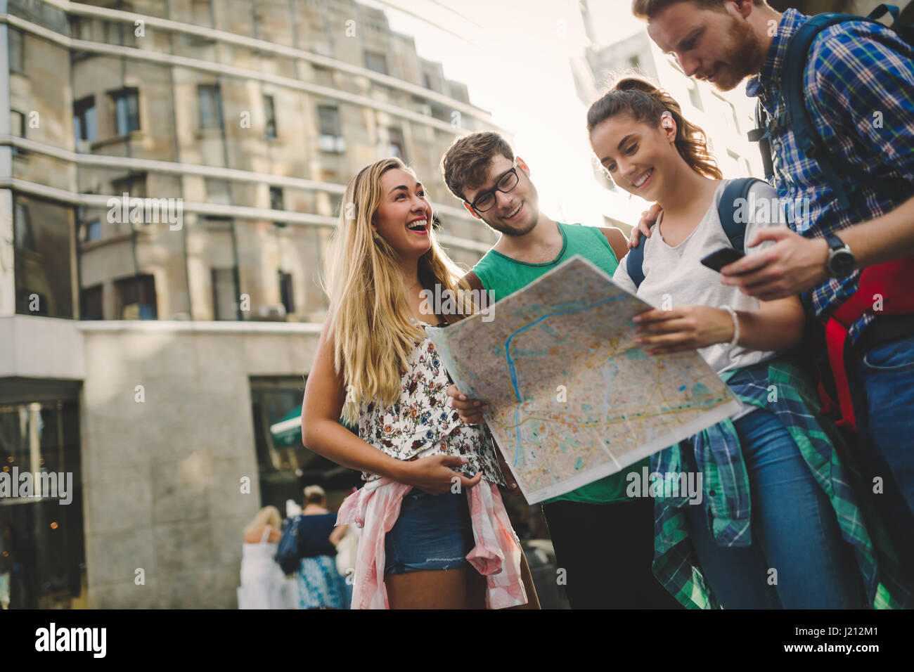 Tourist group of friends discovering city on foot and travelling Stock ...