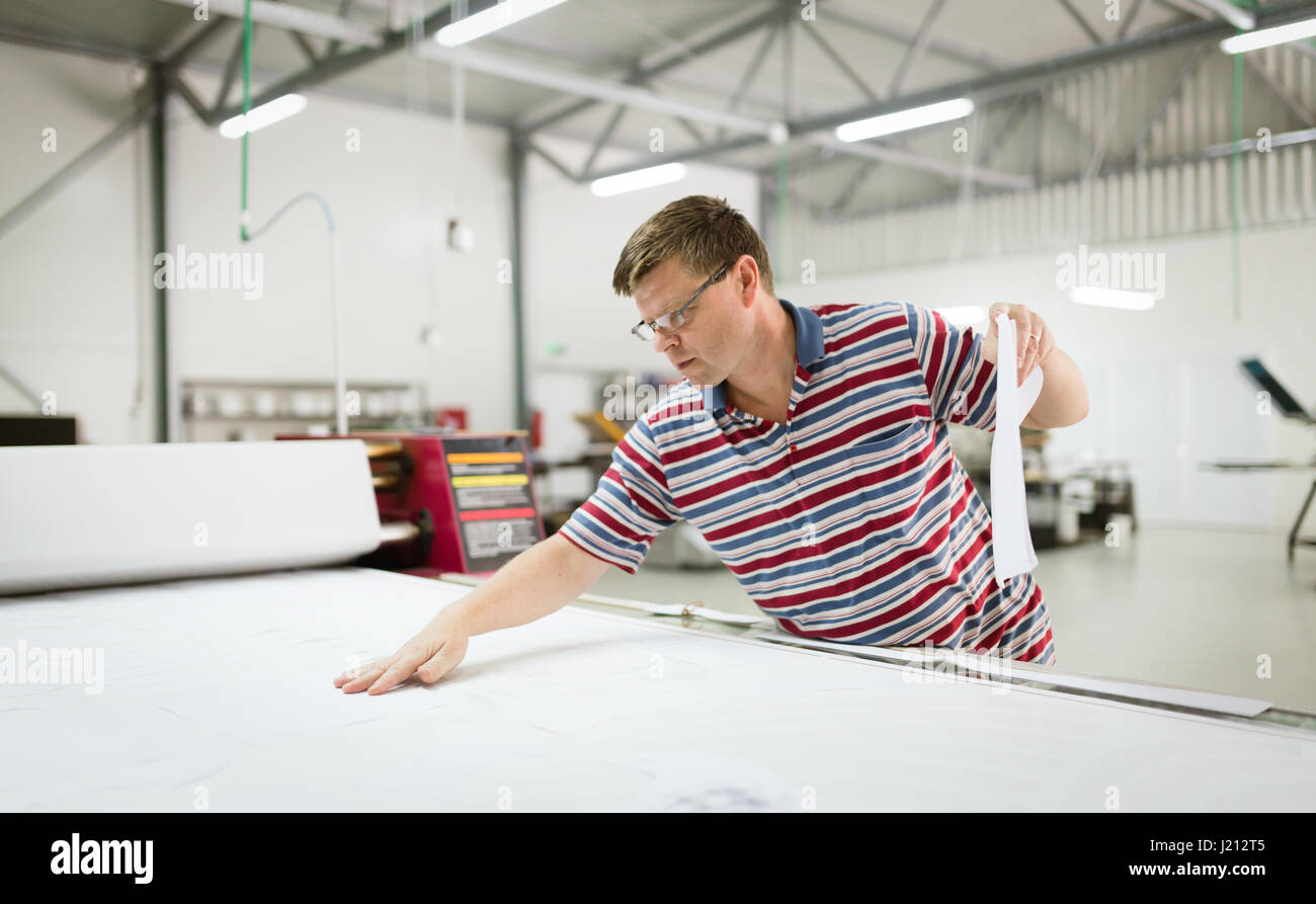 Professional industrial clothing designer working according to scheme ...