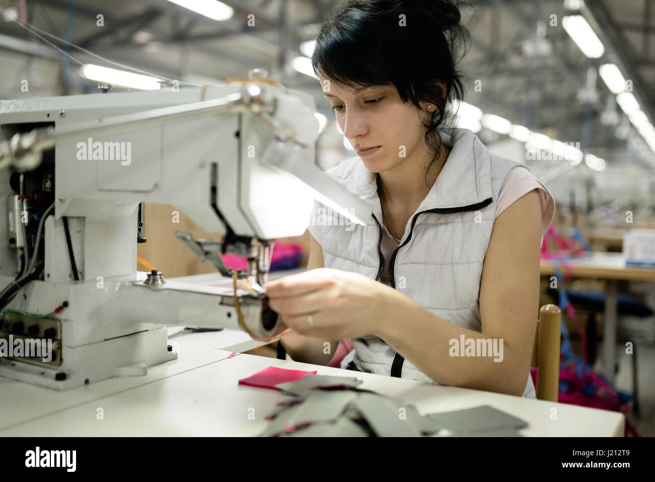 Woman working in sewing industry on machine Stock Photo - Alamy