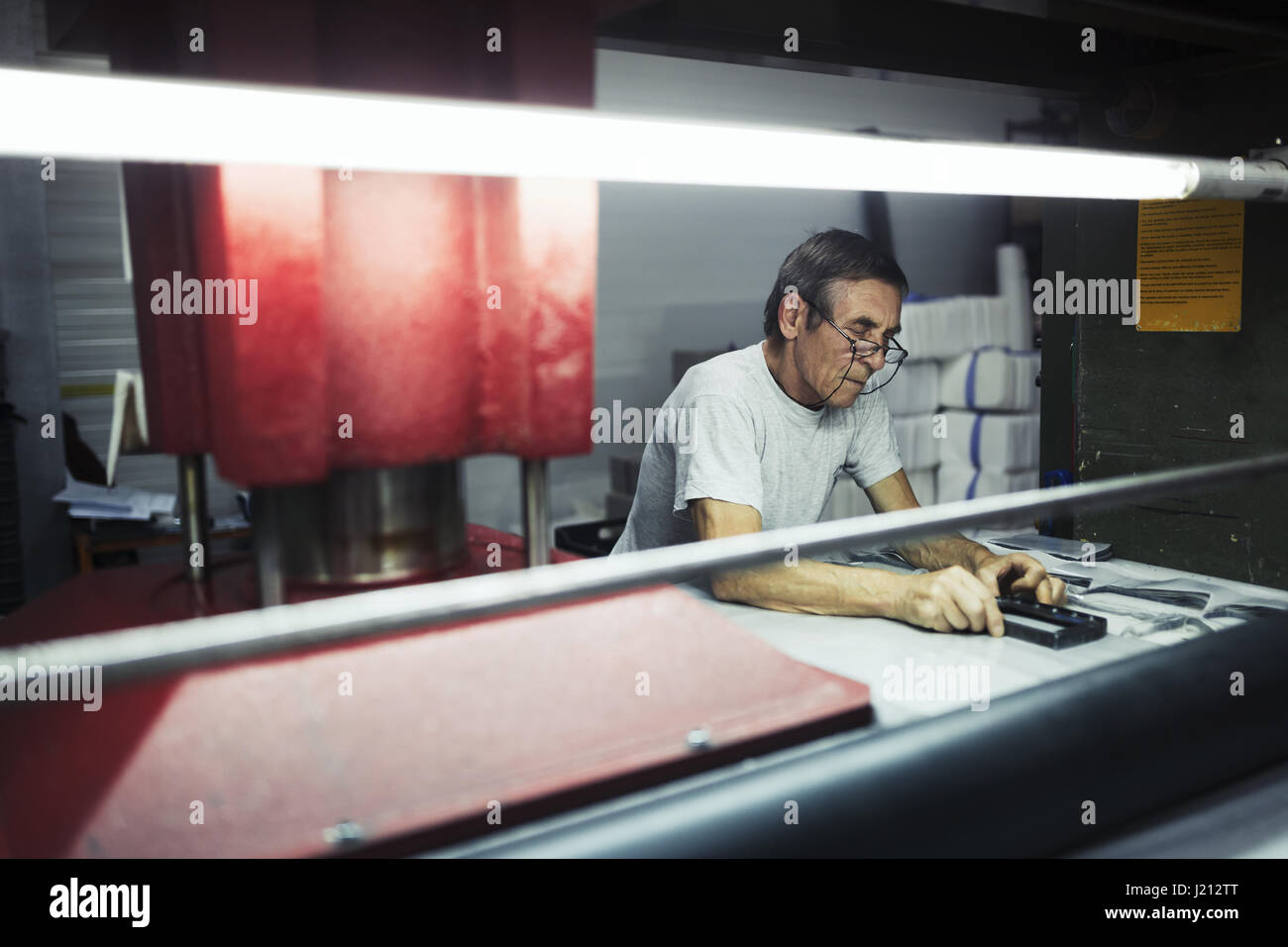 Worker working on pattern cutting industrial machine Stock Photo - Alamy