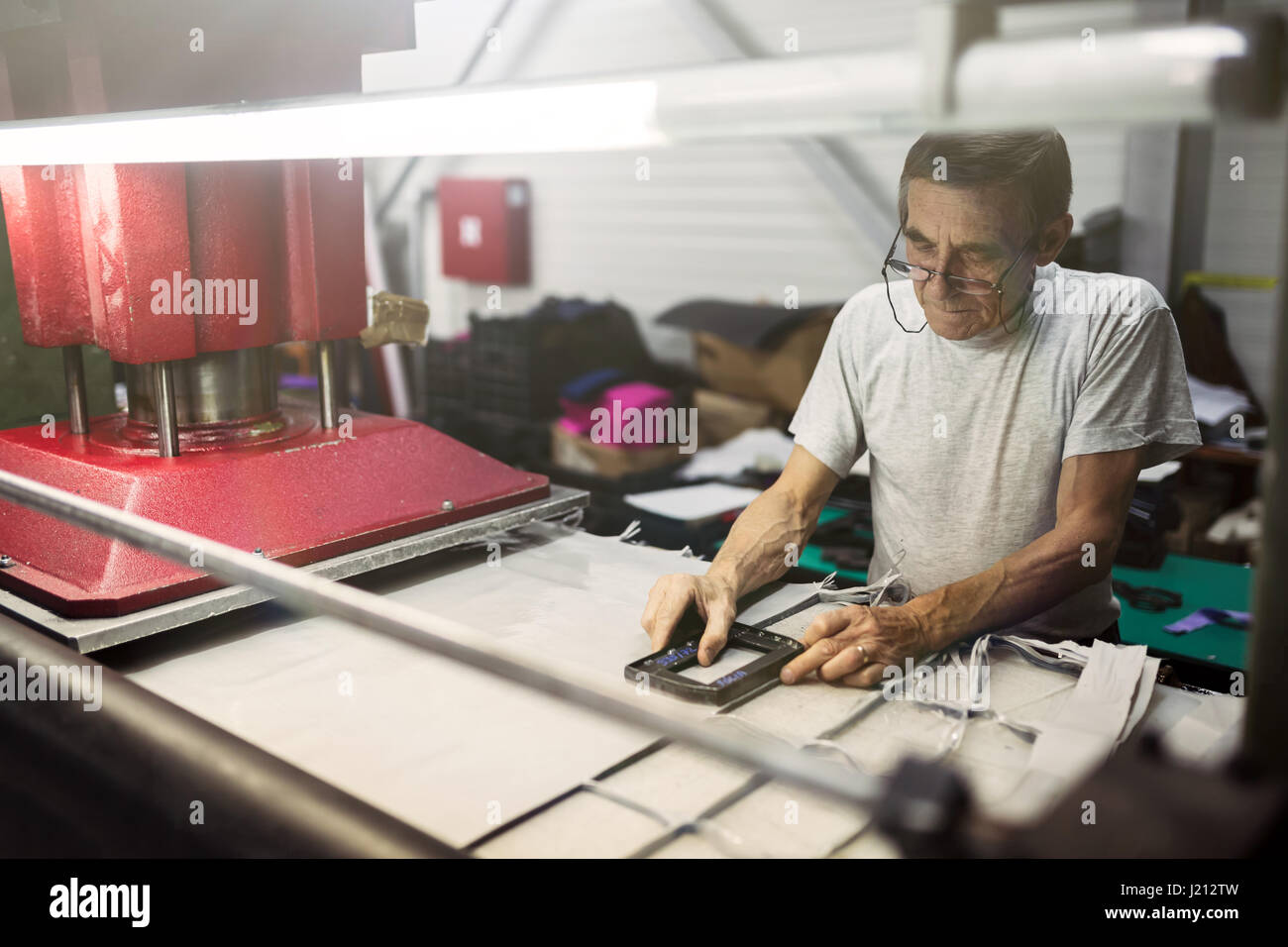 Worker working on pattern cutting industrial machine Stock Photo - Alamy