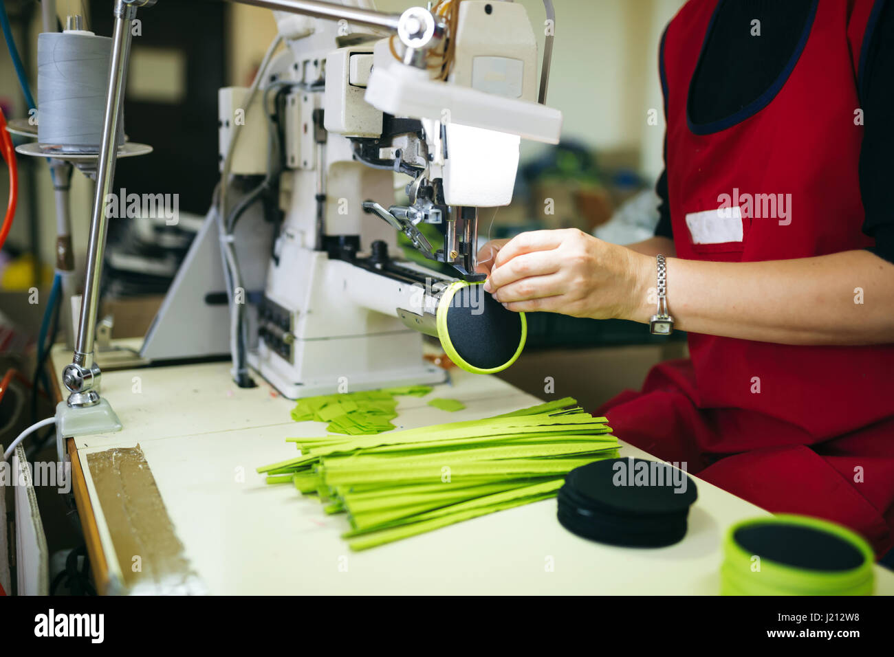 Woman working in sewing industry on machine Stock Photo - Alamy