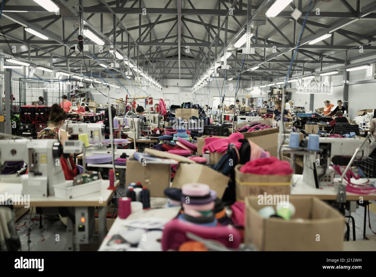 Industrial busy sewing workplace Stock Photo - Alamy