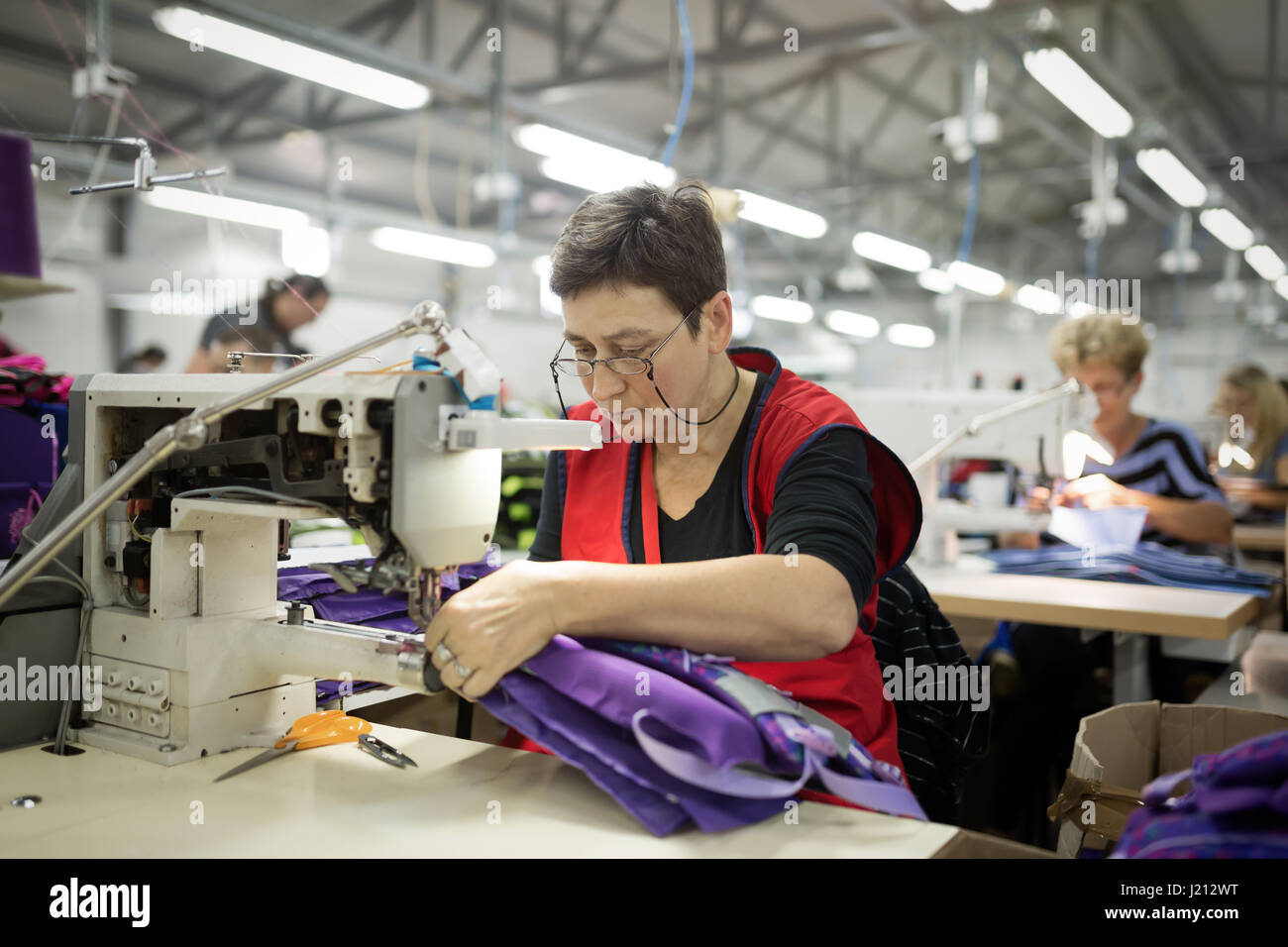 Woman working on professional sewing hi-res stock photography and ...