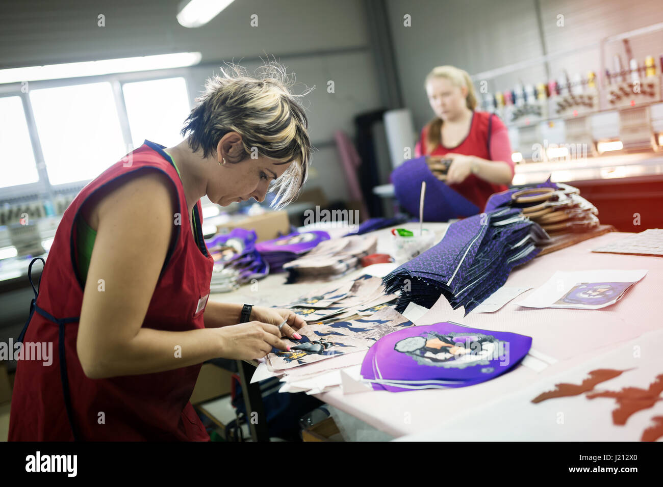 Fabric designers industry workers working with textile Stock Photo - Alamy
