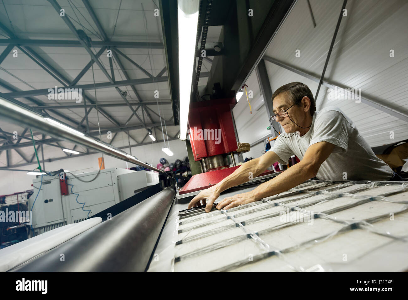 Worker working on pattern cutting industrial machine Stock Photo - Alamy
