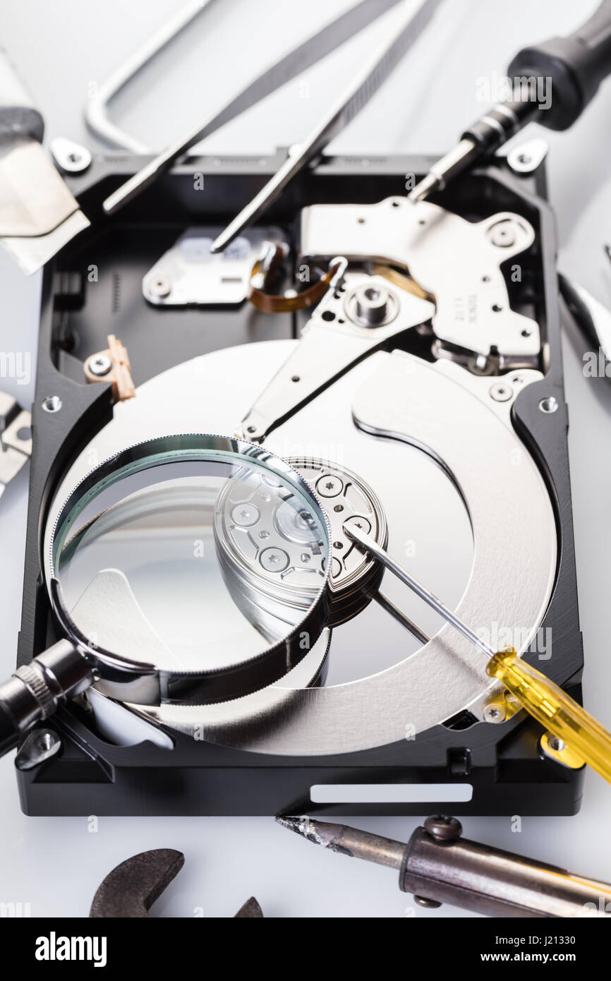 Disassembled computer hard disk and tools close-up Stock Photo - Alamy