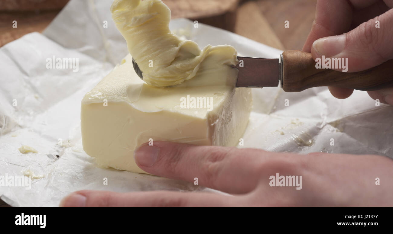 female teen hands scraping butter with a knife, 4k photo Stock Photo ...