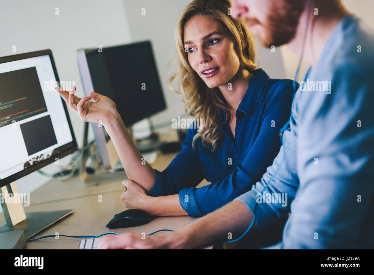 Programmer working in a software developing company office Stock Photo ...