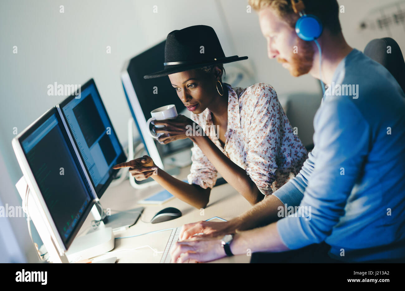 Programmer working in a software developing company office Stock Photo ...