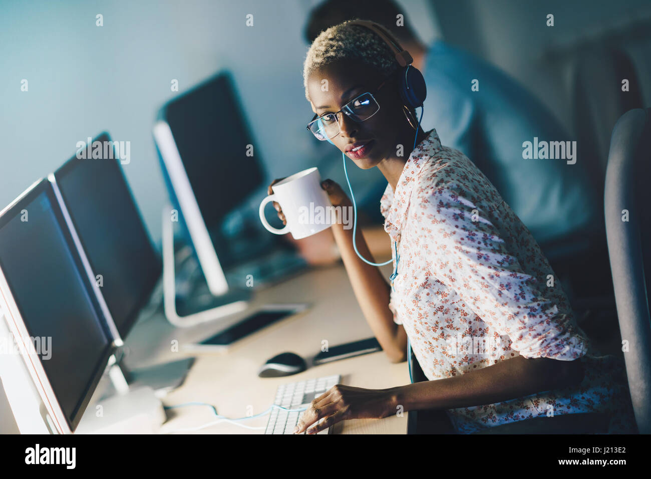 Beautiful female working at IT company as administrator Stock Photo - Alamy