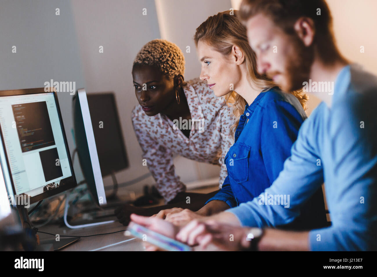 Programmers cooperating at IT company developing apps Stock Photo - Alamy