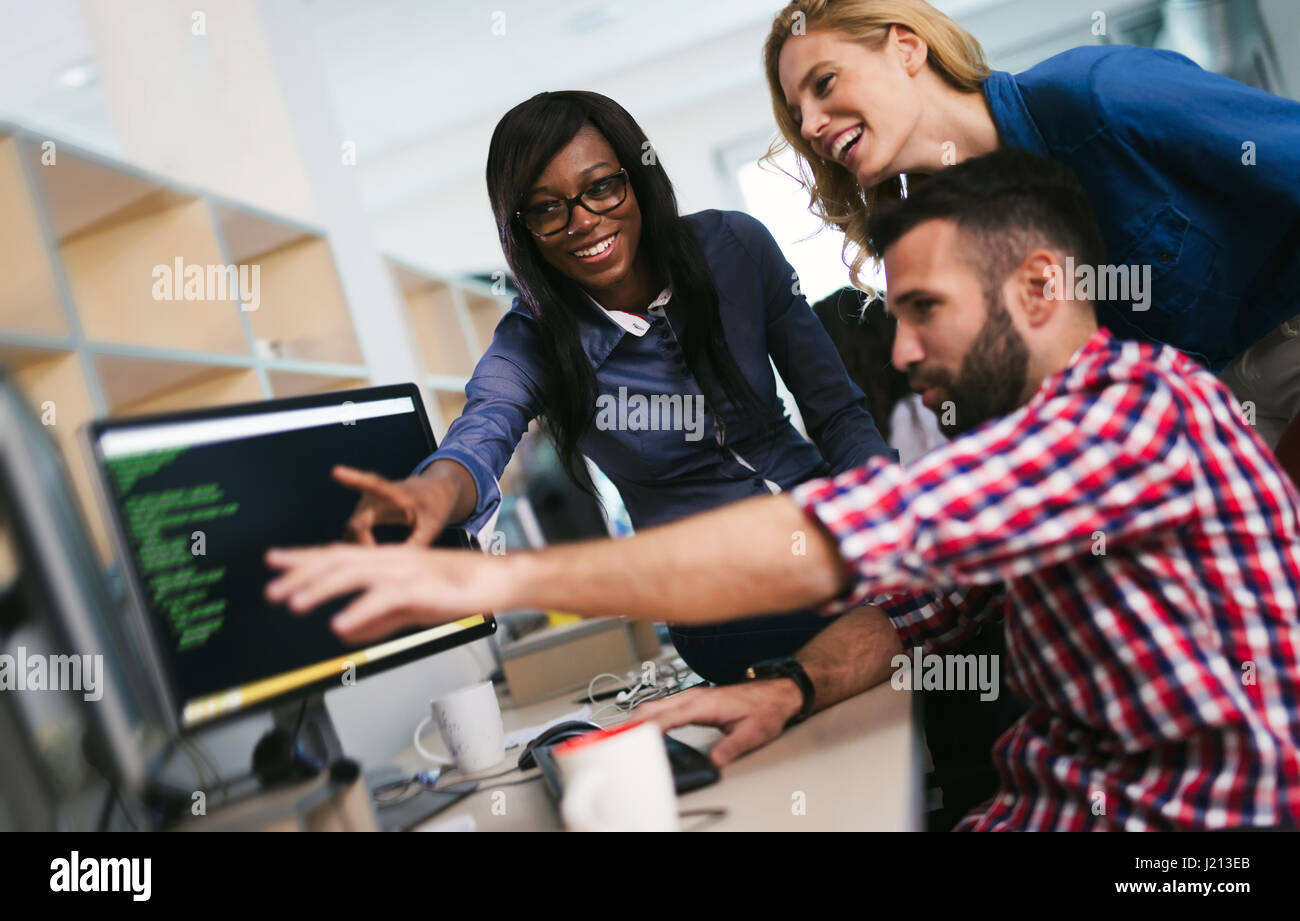 Programmers cooperating at IT company developing apps Stock Photo - Alamy
