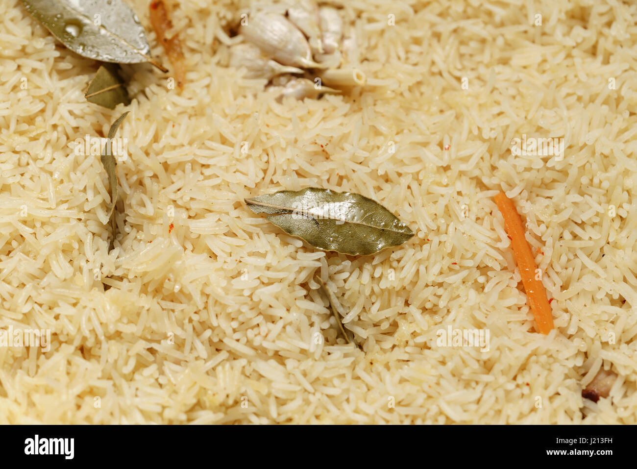 pilaf covered by rice with bay leaves preparing, closeup photo Stock ...