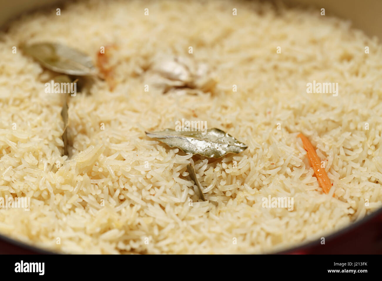 pilaf covered by rice with bay leaves preparing, closeup photo Stock ...