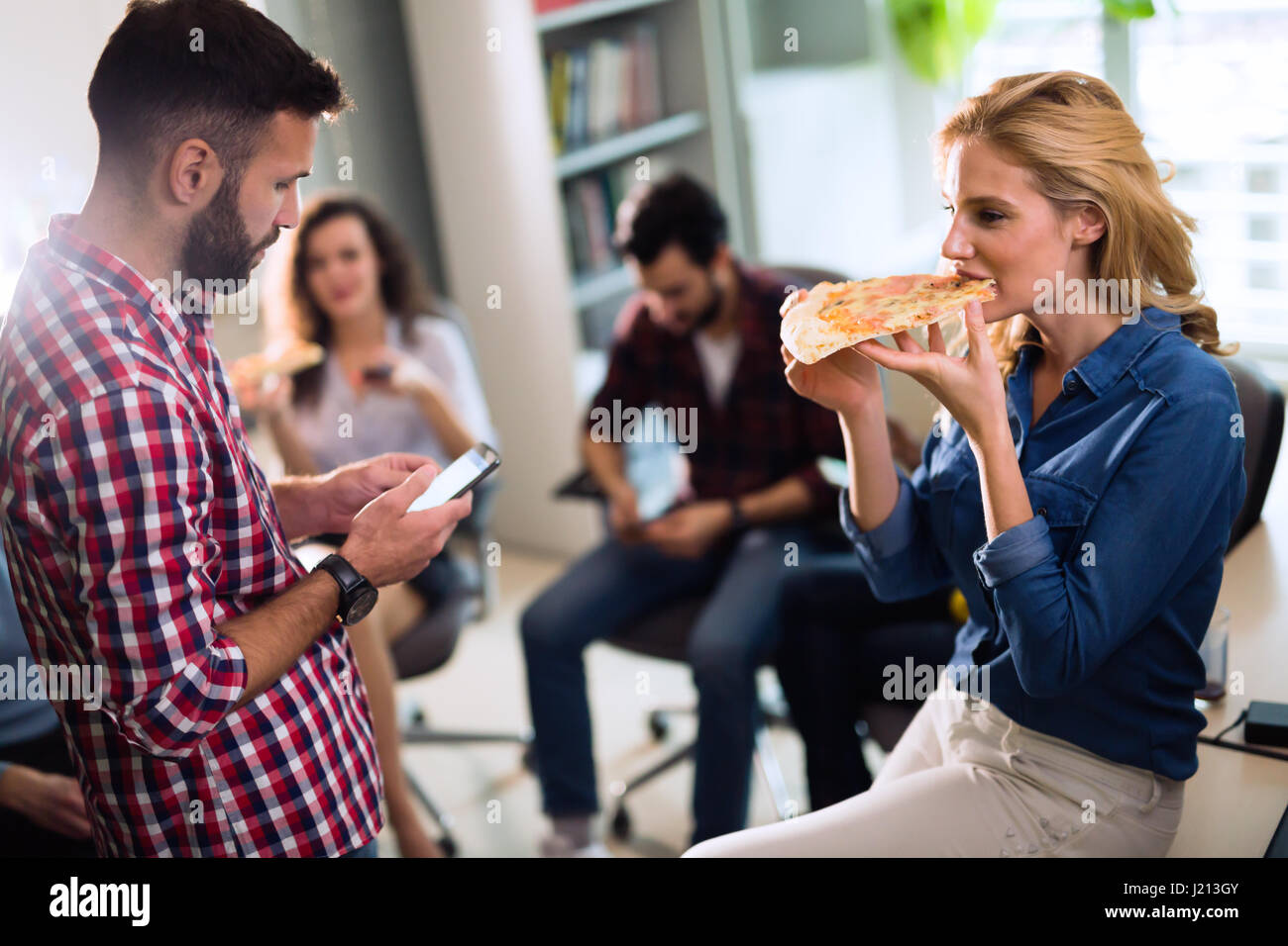 Colleagues corporate lunch break at work in company offices Stock Photo ...