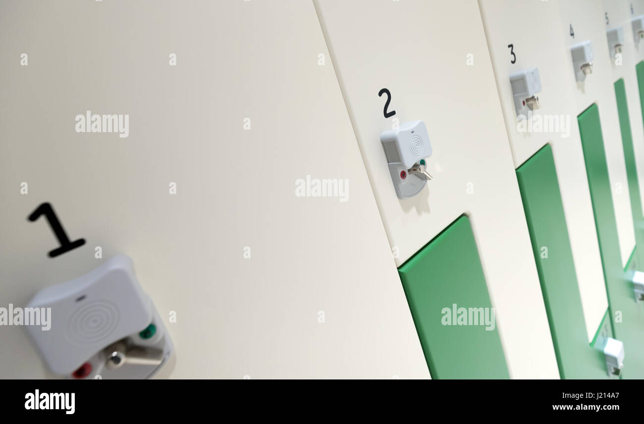 Locker room with security compartments in a row Stock Photo - Alamy