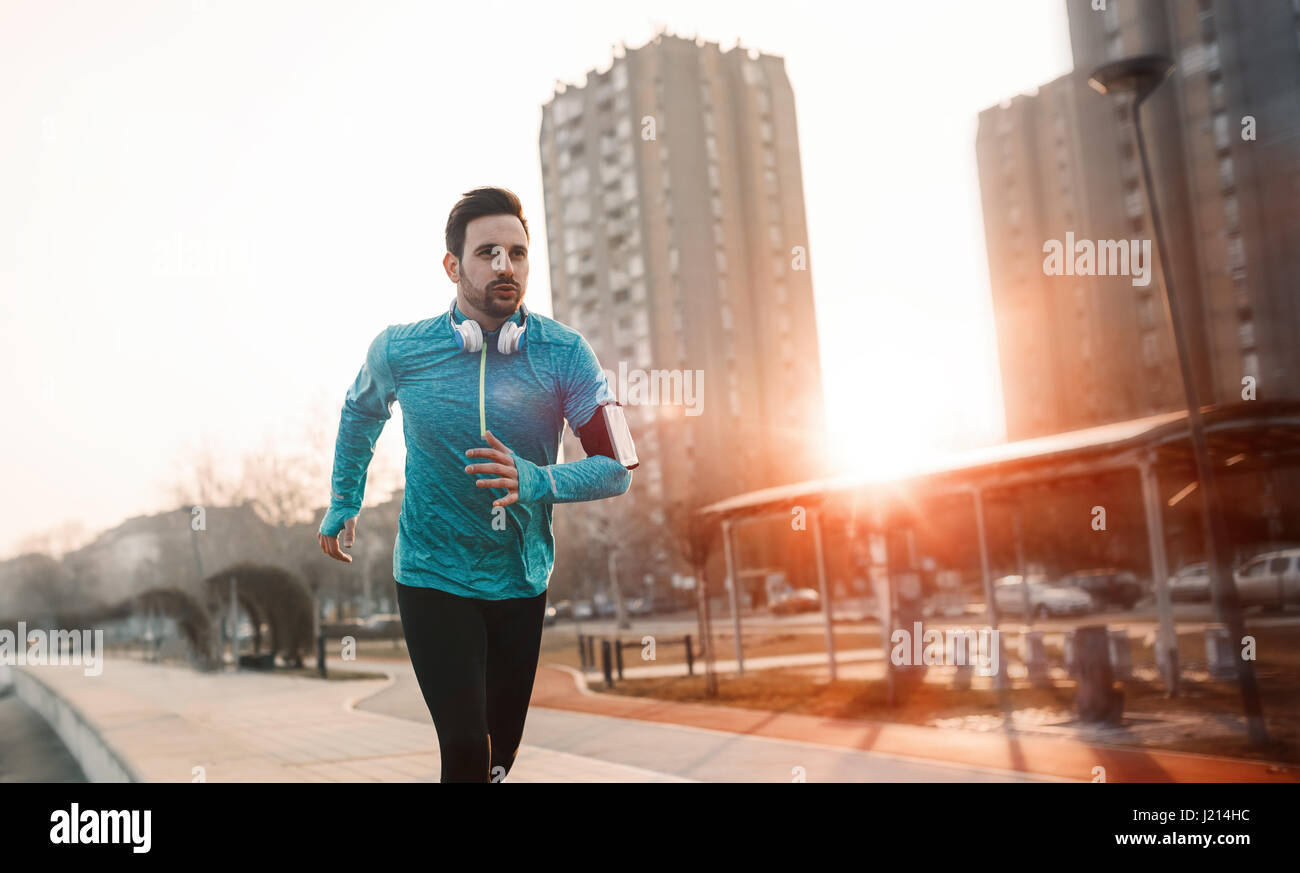 Handsome sportsman exercising outdoor by jogging and running Stock ...