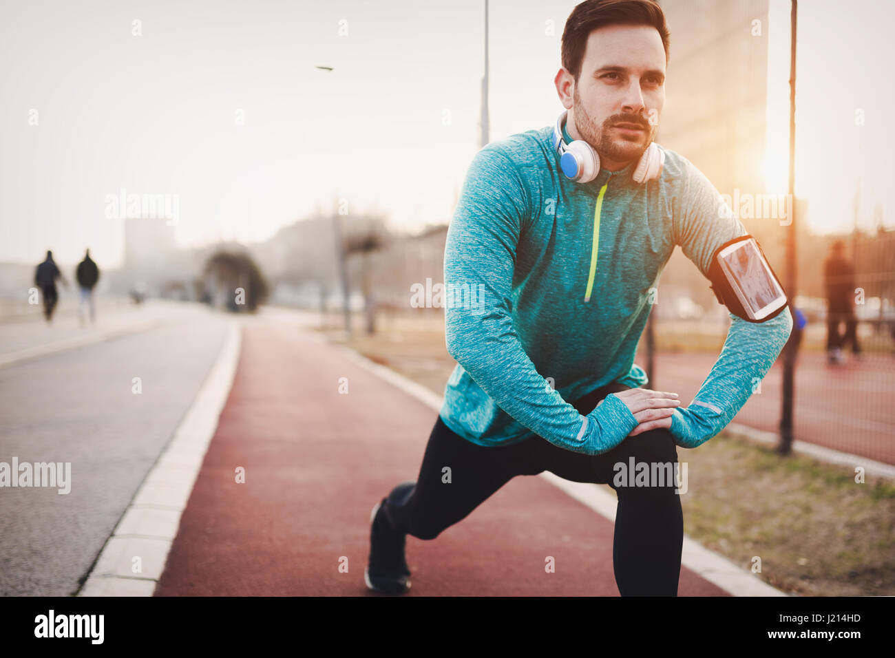 Handsome man stretching before exercising and running Stock Photo - Alamy
