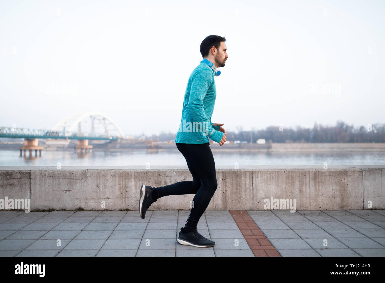 Sportsman in outfit running and jogging in city Stock Photo - Alamy
