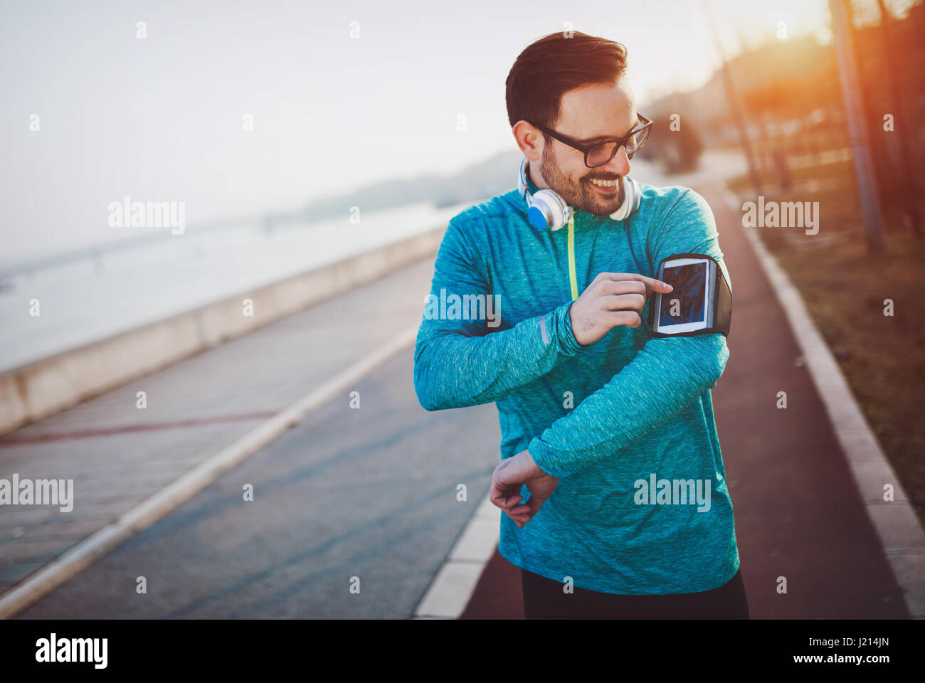 Handsome healthy sportsman exercising while enjoying music Stock Photo ...