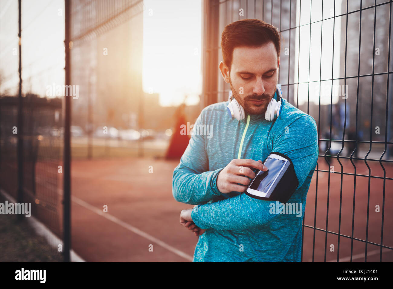 Handsome healthy sportsman exercising while enjoying music Stock Photo ...