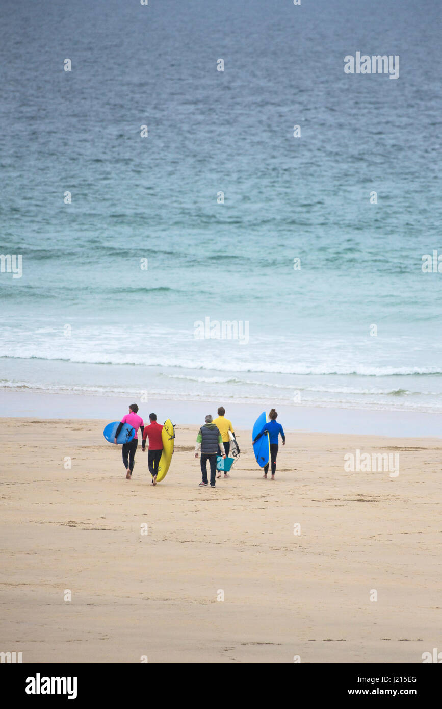 UK surfing Surfers walking to the sea Group of surfers Surfers carrying ...