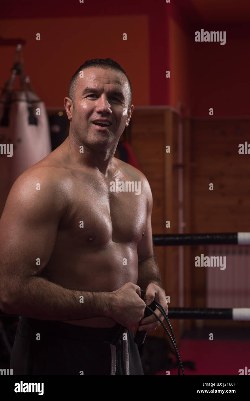 portrait of muscular professional kickboxer who standing in the ring ...