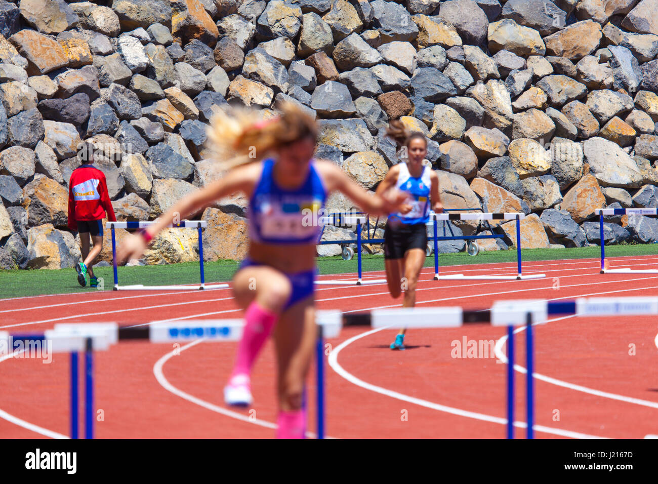 young girls doing Hurdling on a the track and field stadium CIAT in ...