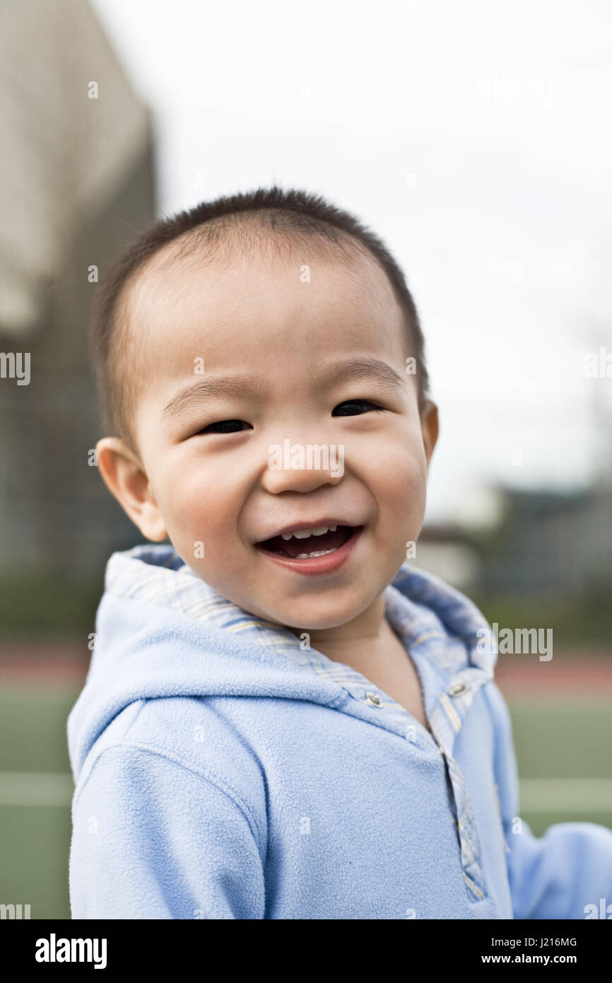 A shot of a happy asian boy laughing Stock Photo - Alamy