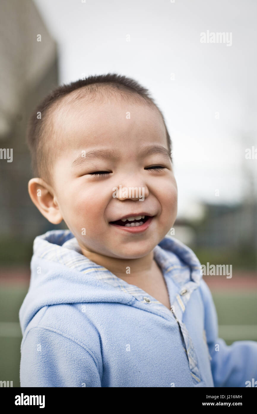 A shot of a happy asian boy laughing Stock Photo - Alamy