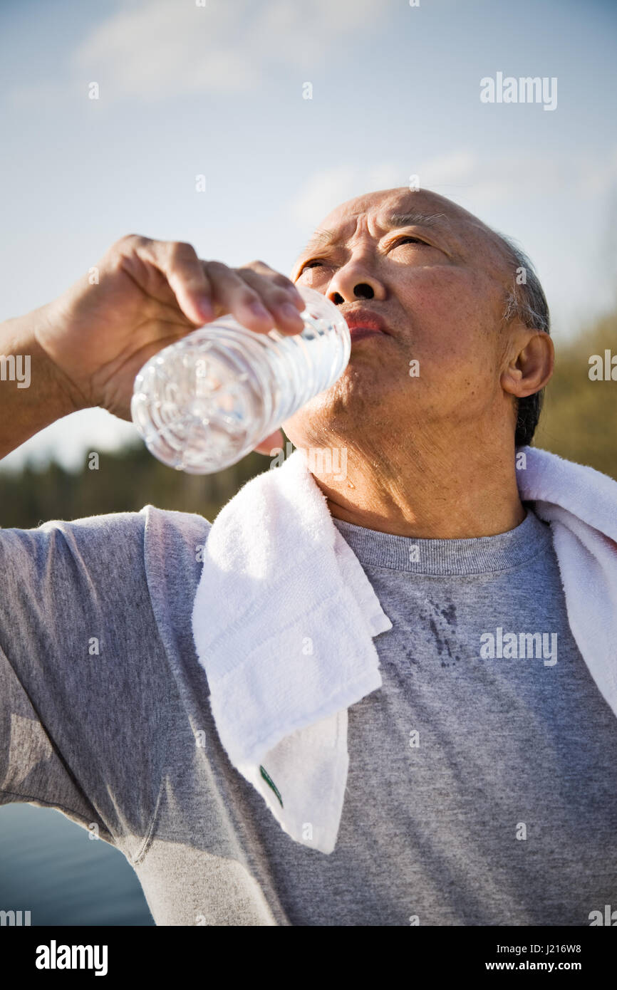 An active senior asian man drinking water after exercise Stock Photo ...